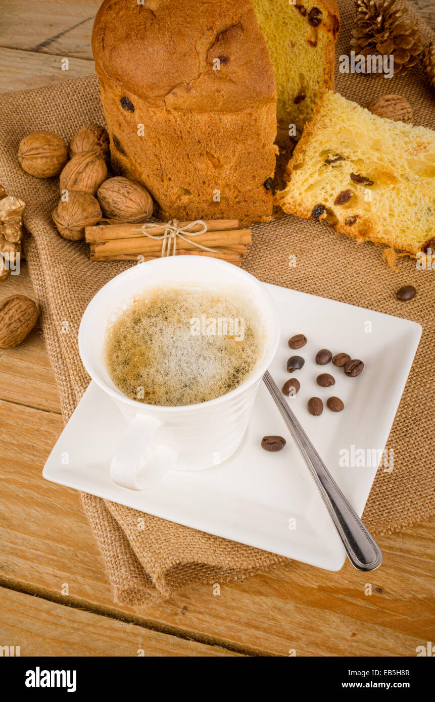 Homemade panettone with a cup of cappuccino and some ingredients Stock ...
