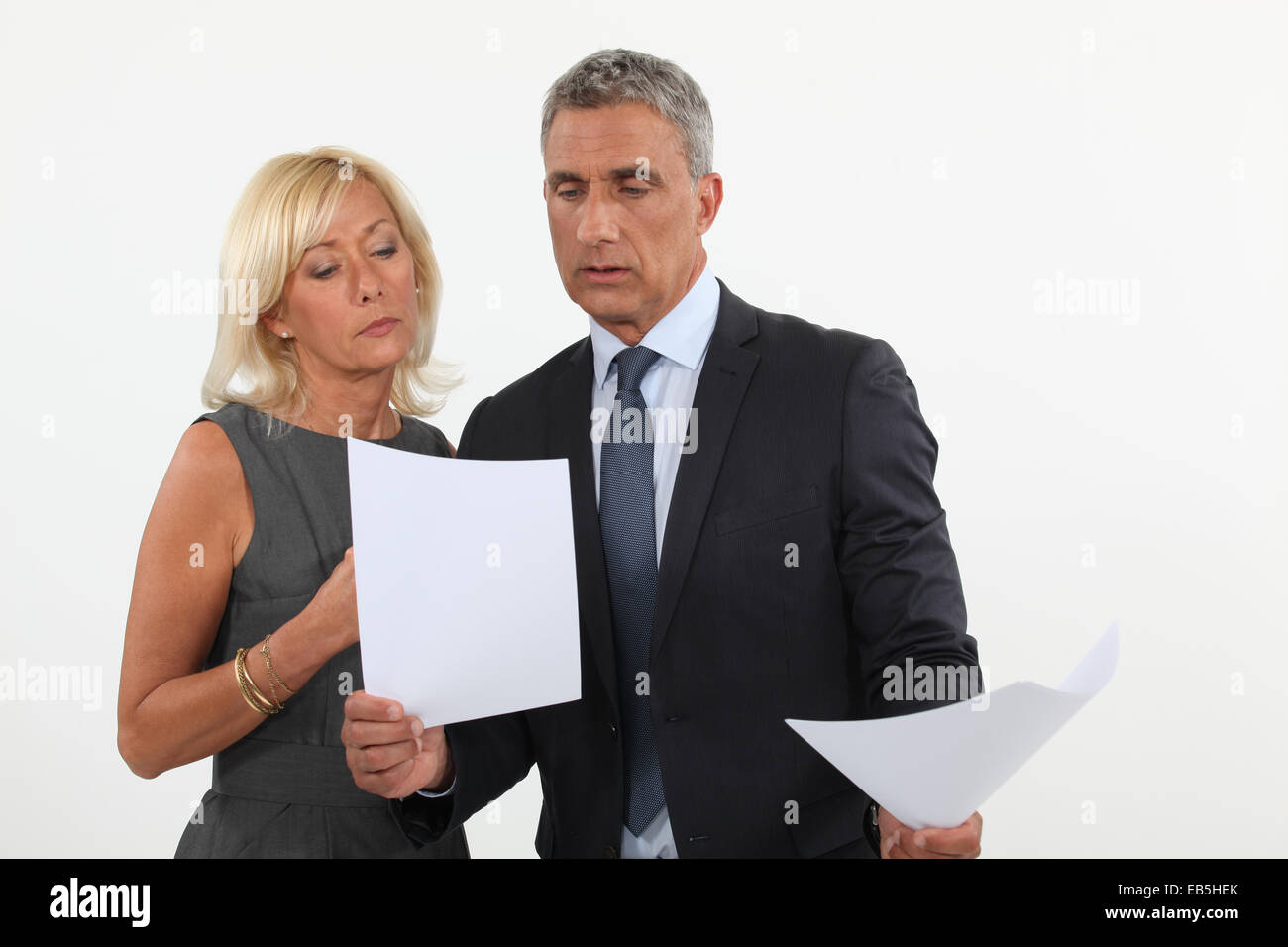 A couple of businesspeople going through papers Stock Photo - Alamy