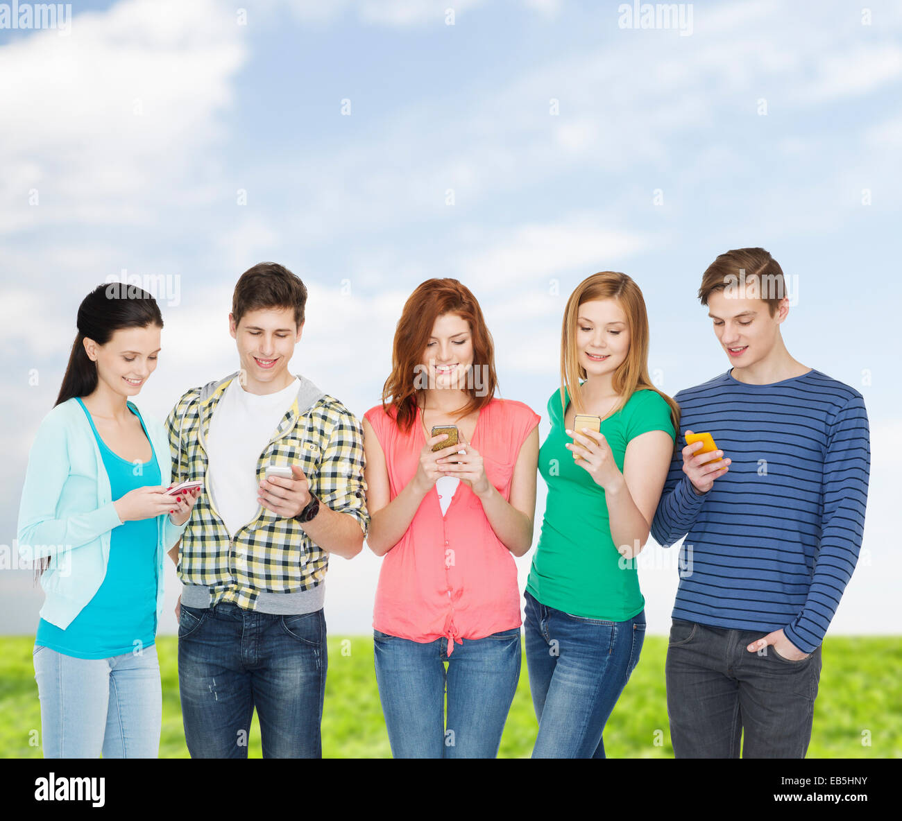 smiling students with smartphones Stock Photo - Alamy