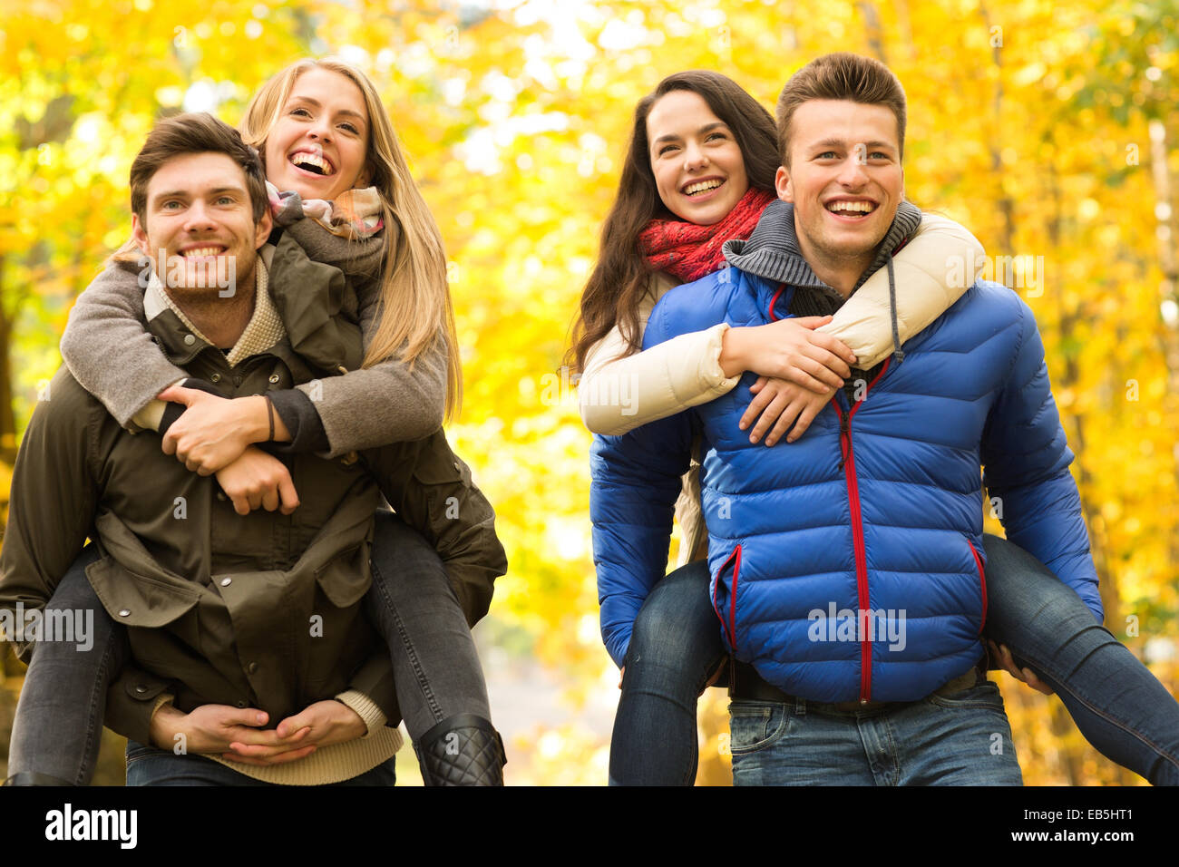 smiling friends having fun in autumn park Stock Photo - Alamy