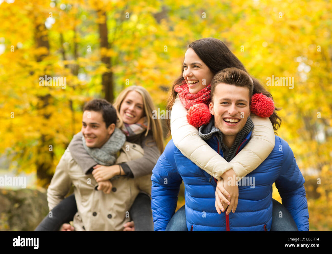 smiling friends having fun in autumn park Stock Photo - Alamy