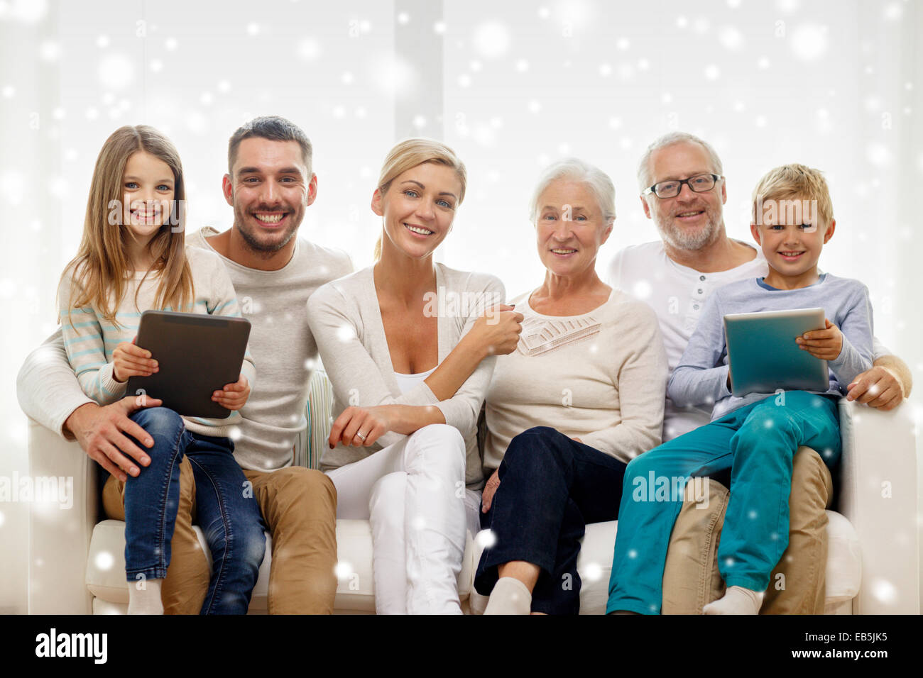smiling family with tablet pc computers at home Stock Photo - Alamy