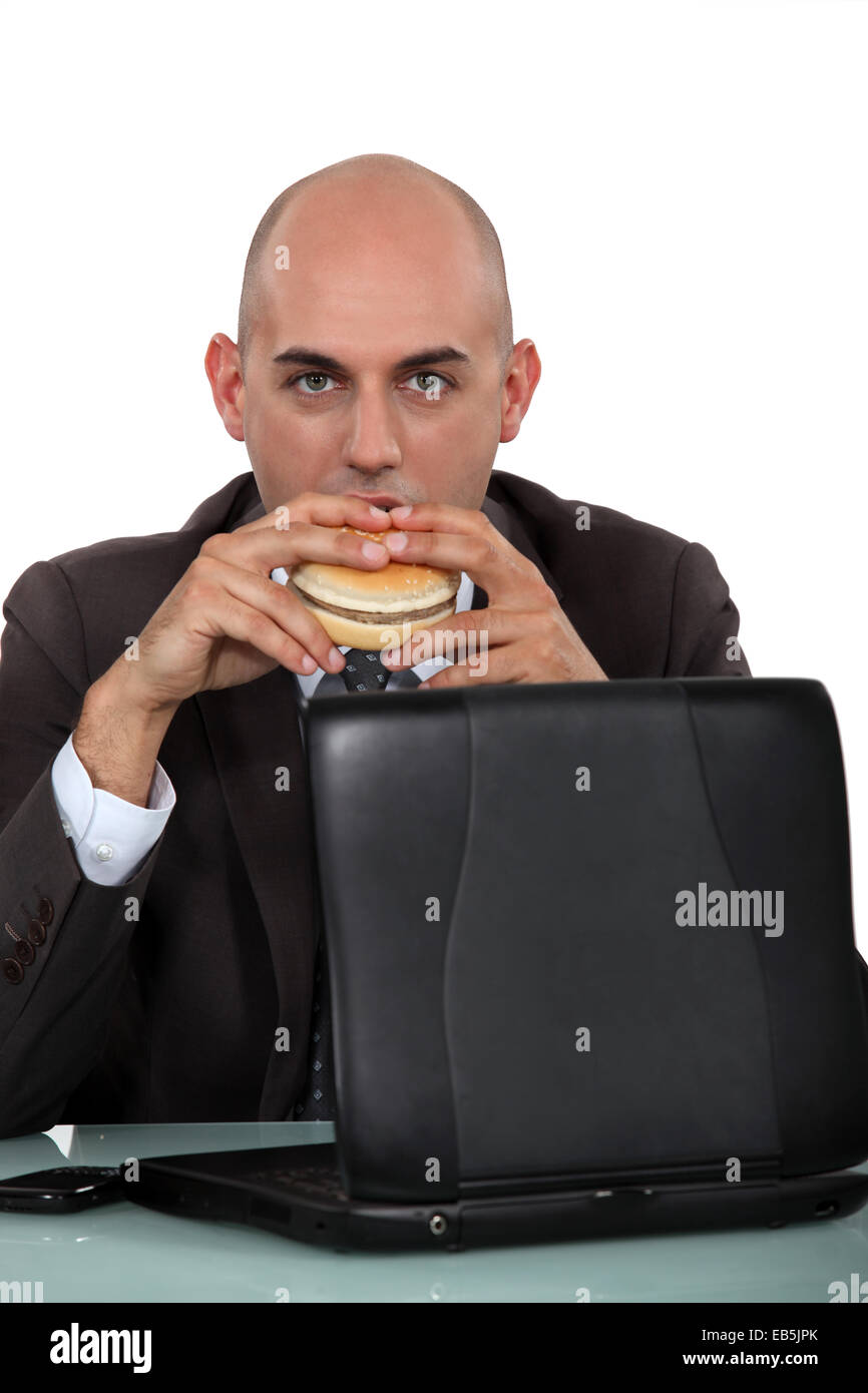 Hungry businessman manager eating sandwich hi-res stock photography and ...
