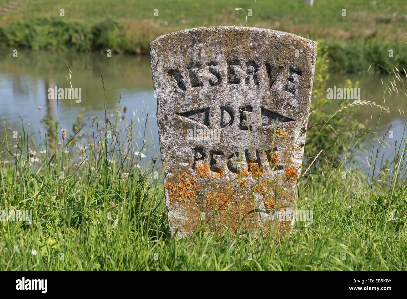 Stone sign post by a river Stock Photo - Alamy