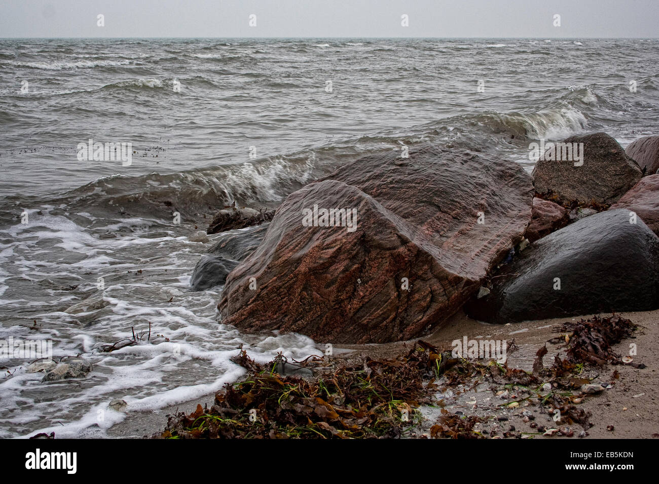 Rocks on a beach on a gray summer day Stock Photo - Alamy