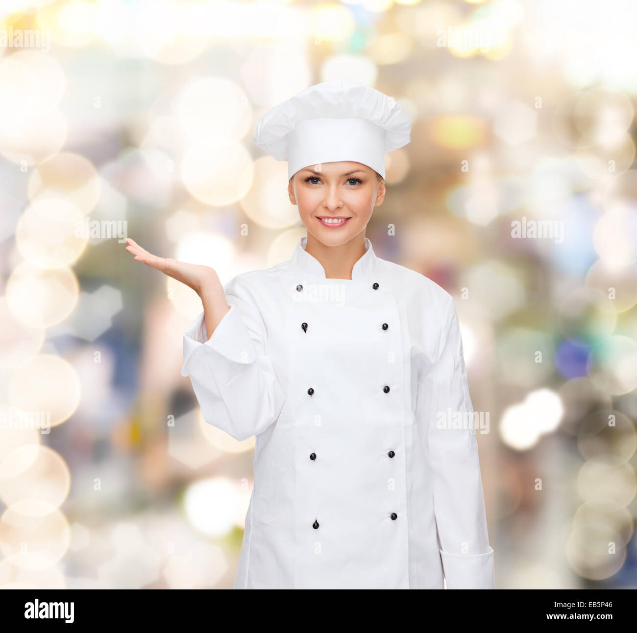 smiling female chef holding something on hand Stock Photo - Alamy