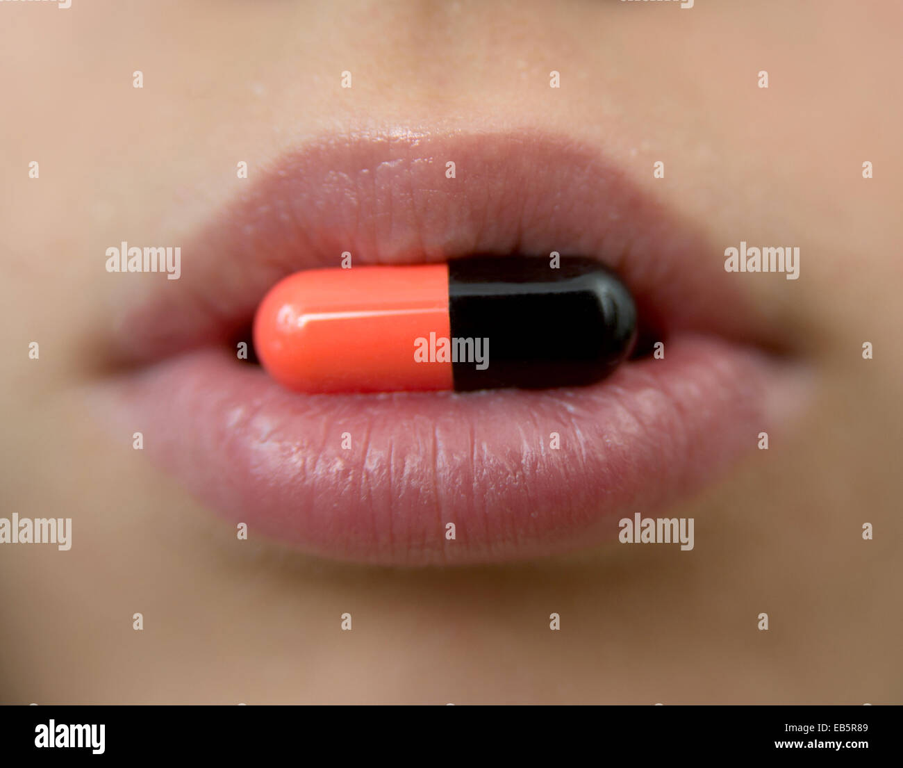 Woman taking pill red lips hi-res stock photography and images - Alamy