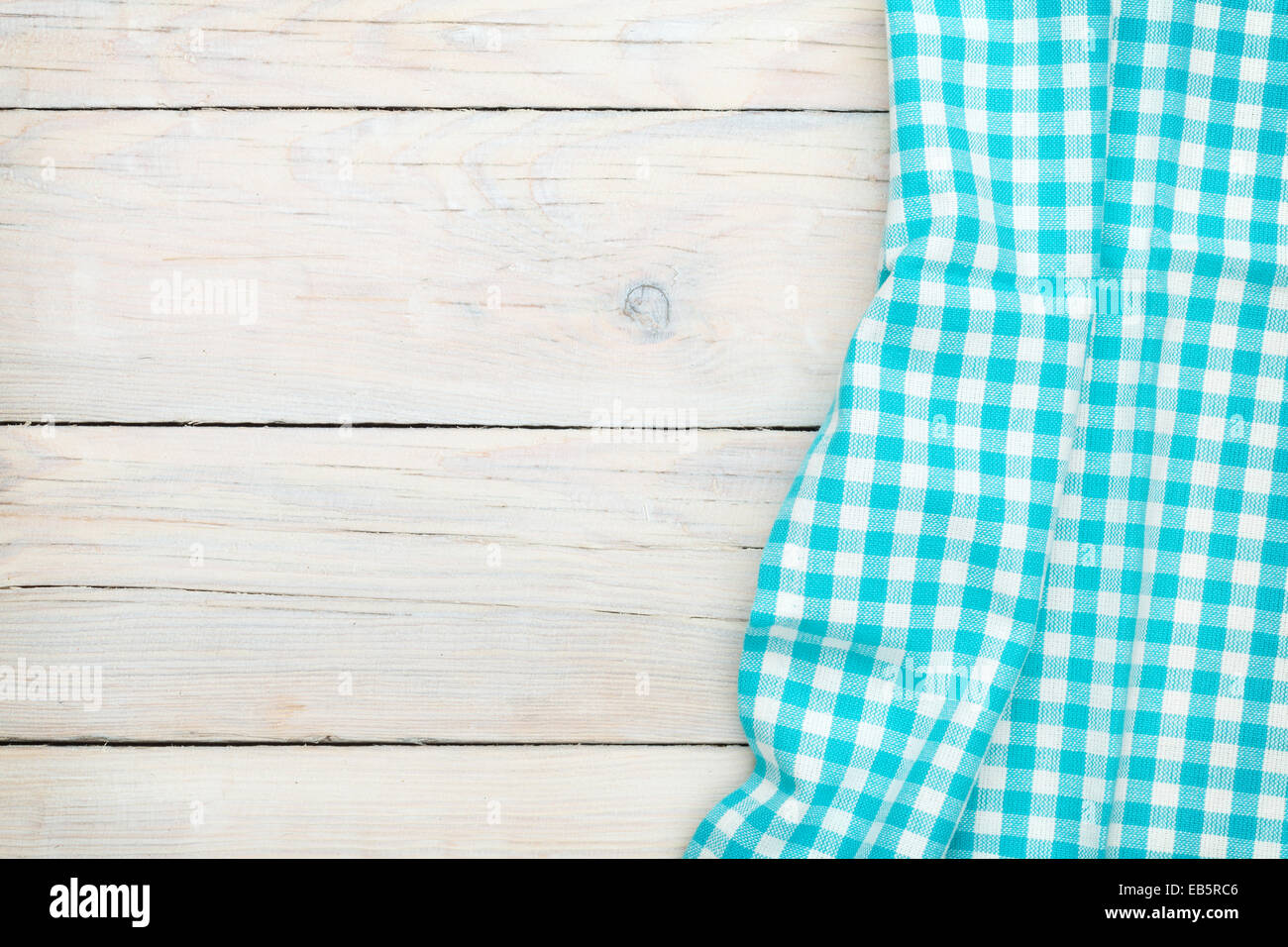 Blue towel over wooden kitchen table. View from above with copy space ...