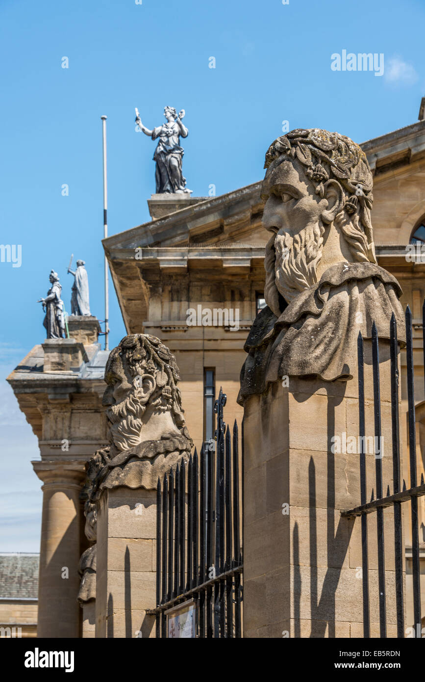 Grotesque decorative stone figure heads outside the Sheldonian Theatre ...