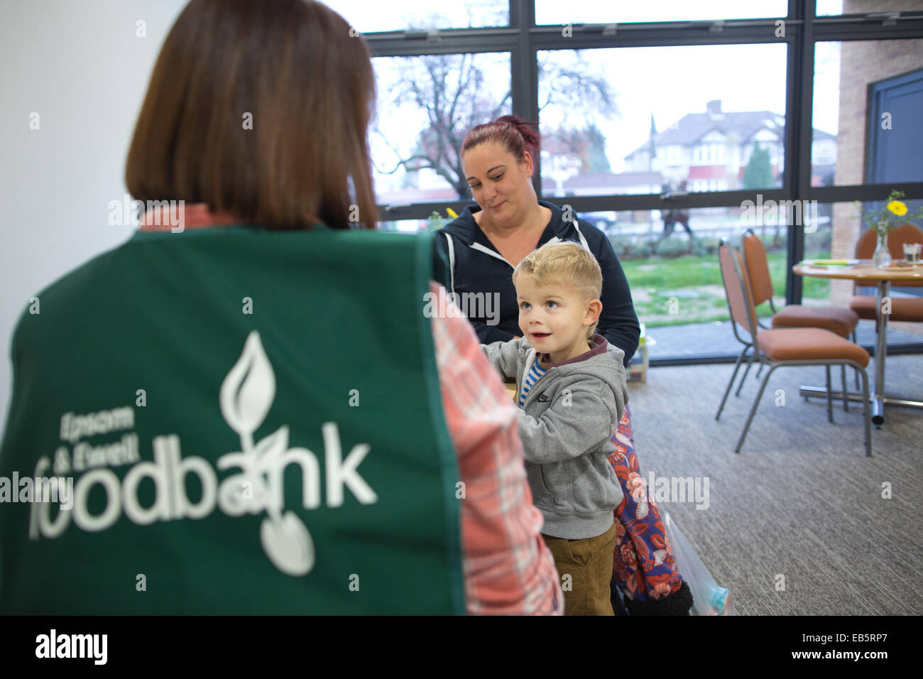 A family receiving advice at Epsom Foodbank, food donations for ...