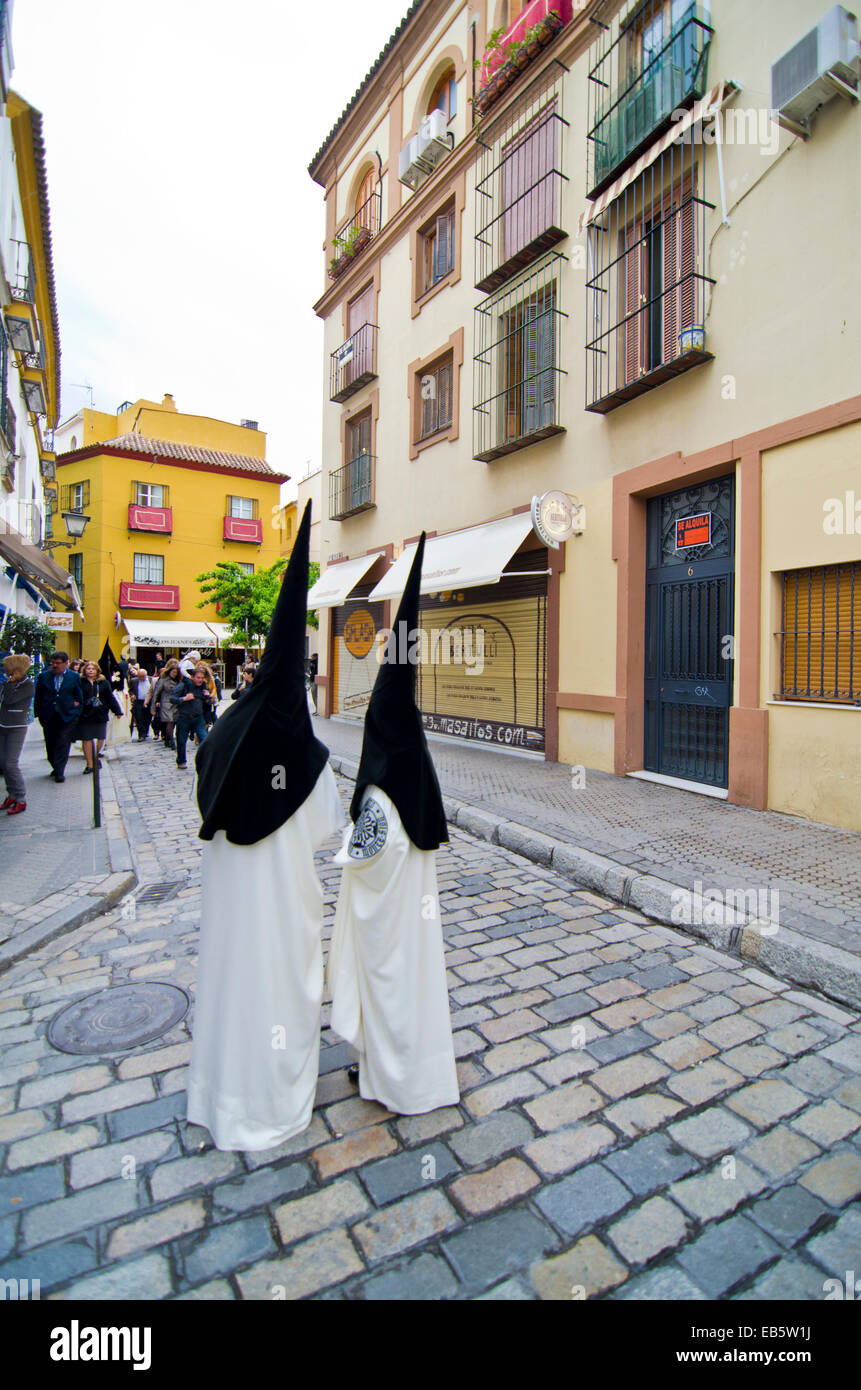 Penitents in Seville street during Holy week celebration, Andalusia ...