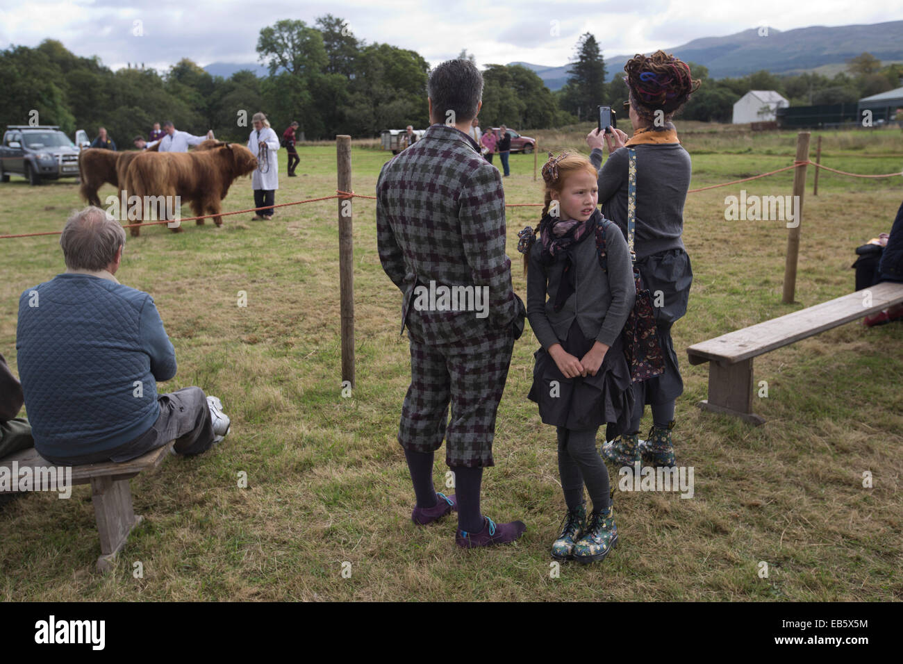 A family watching the judging of the Highland cattle competition at the ...