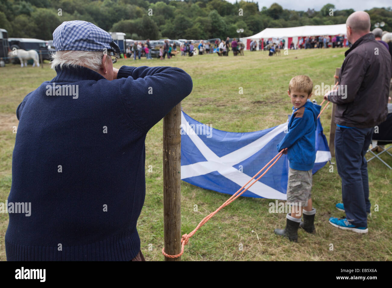 People staring next to a Scottish flag watching the Dalmally ...