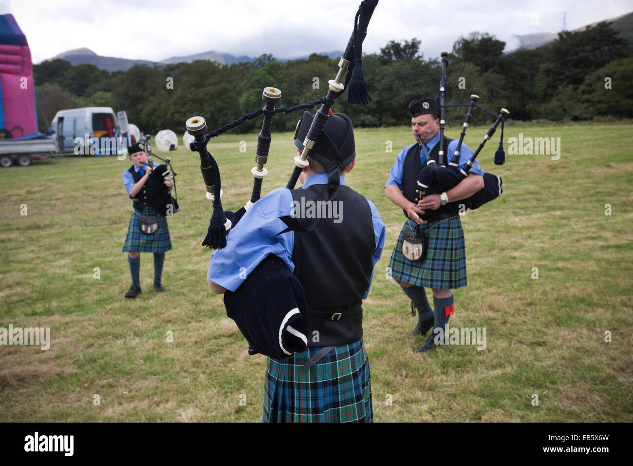 Three members of a traditional Scottish pipe band playing at the ...