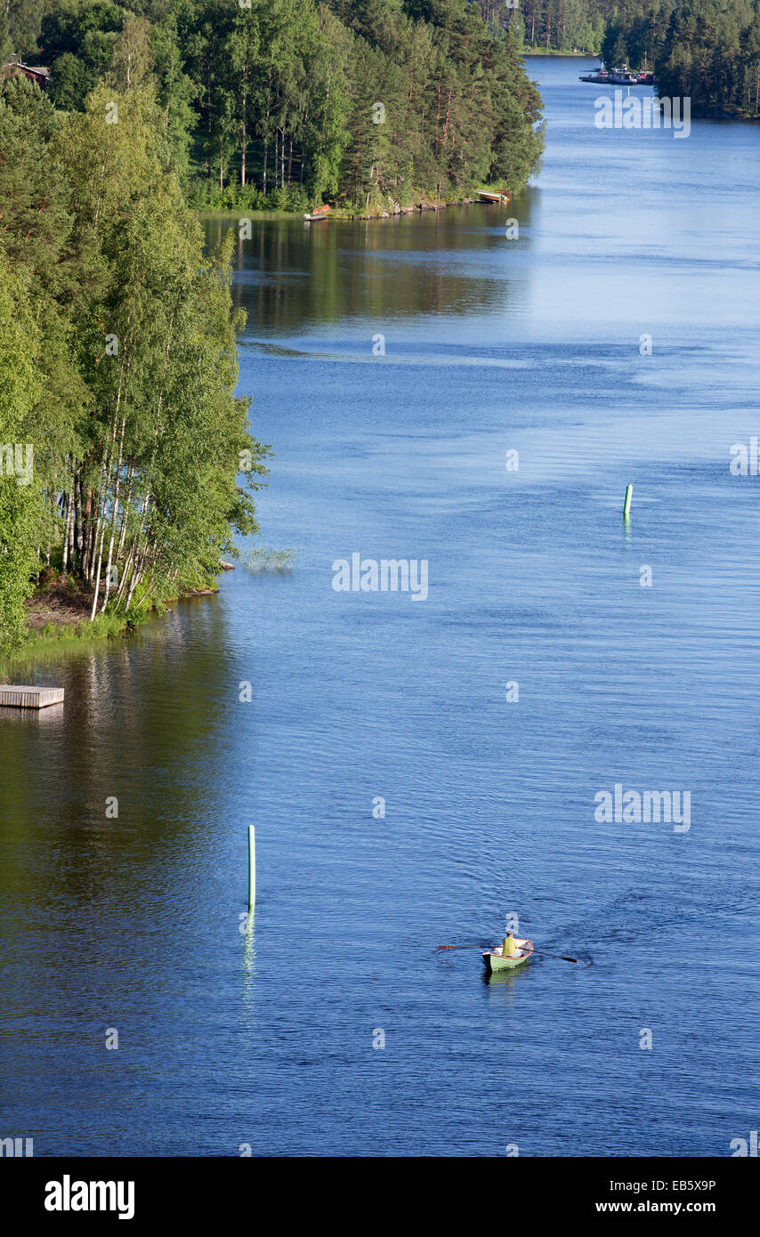 Aerial view of a man rowing a rowboat / skiff / dinghy at Leppävirta ...