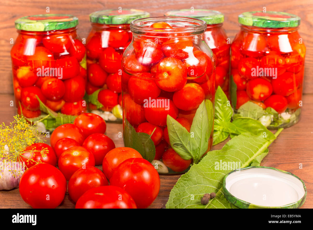 canning tomatoes in glass jars with spices Stock Photo - Alamy