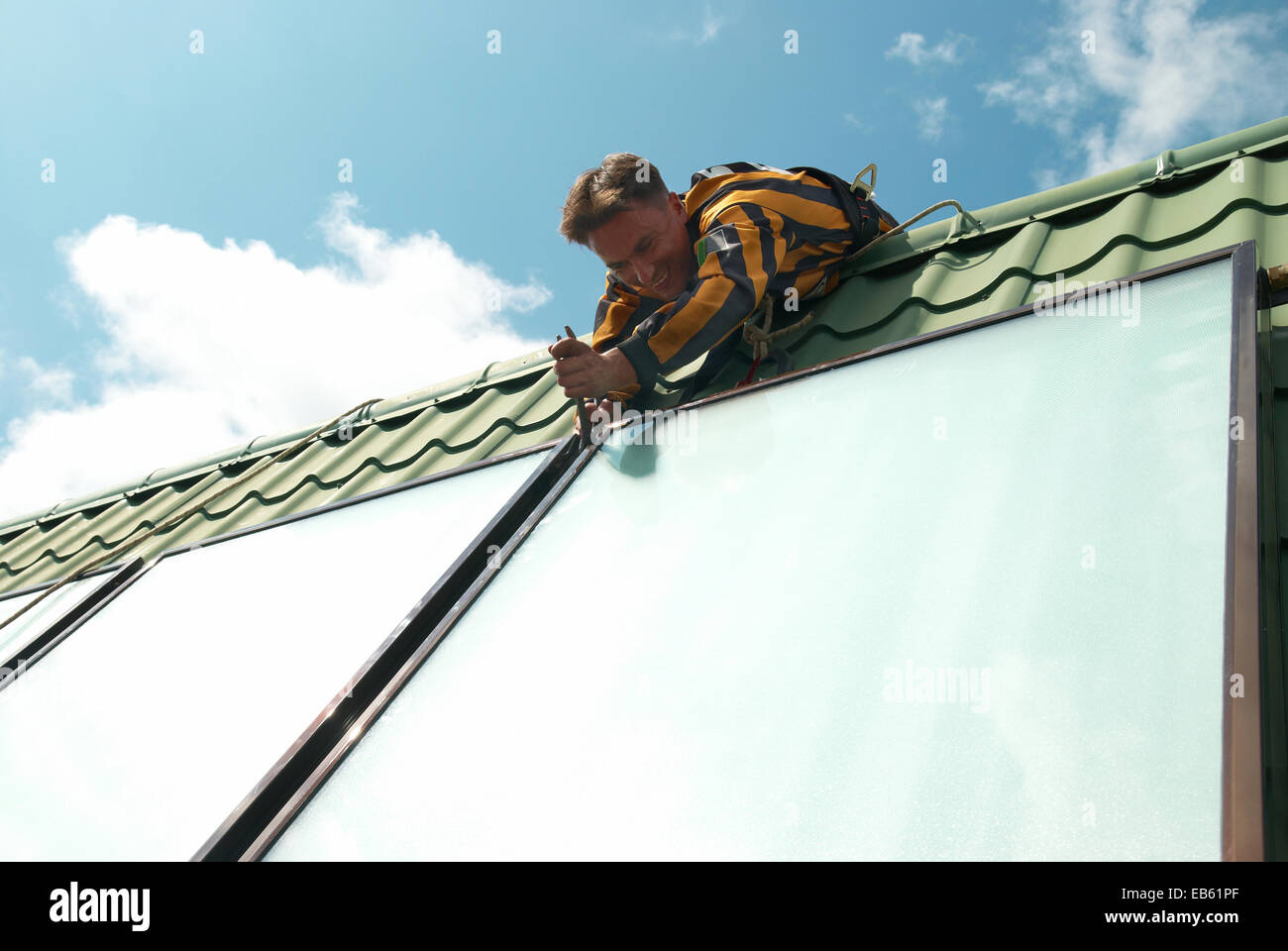Erector of solar water heating system on the roof Stock Photo - Alamy