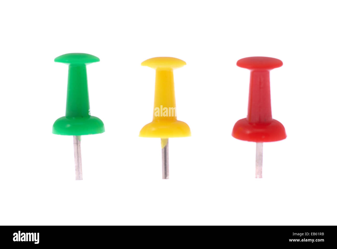 Three colored pins isolated on white background Stock Photo - Alamy