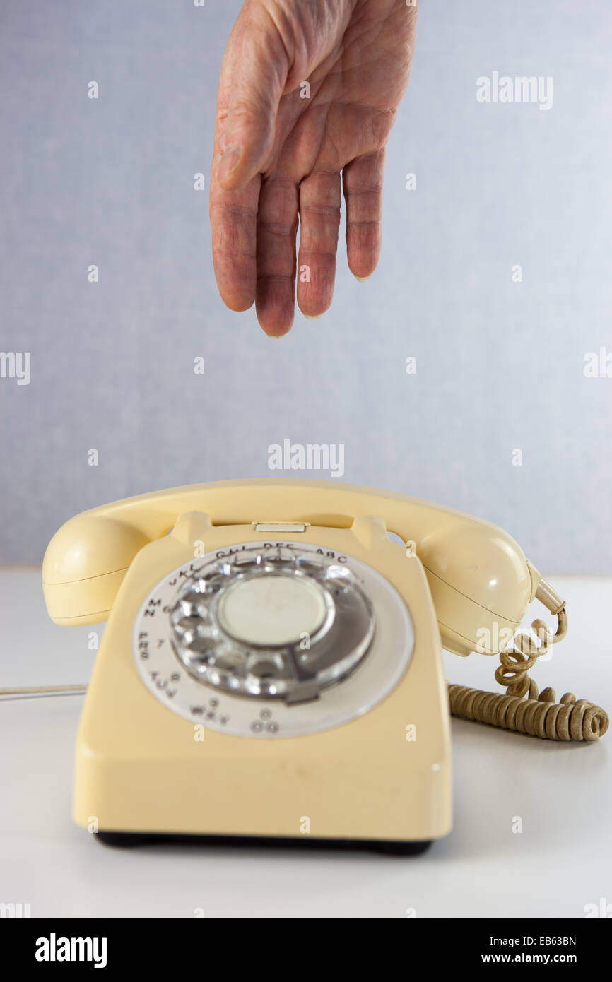 Answering an old fashioned rotary dial telephone Stock Photo - Alamy