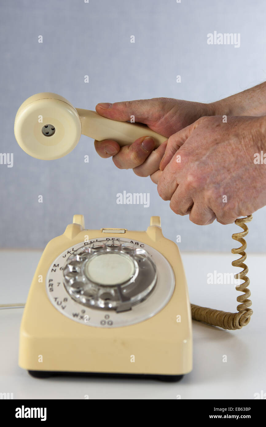 Covering the mouth piece of an old fashioned rotary dial telephone ...