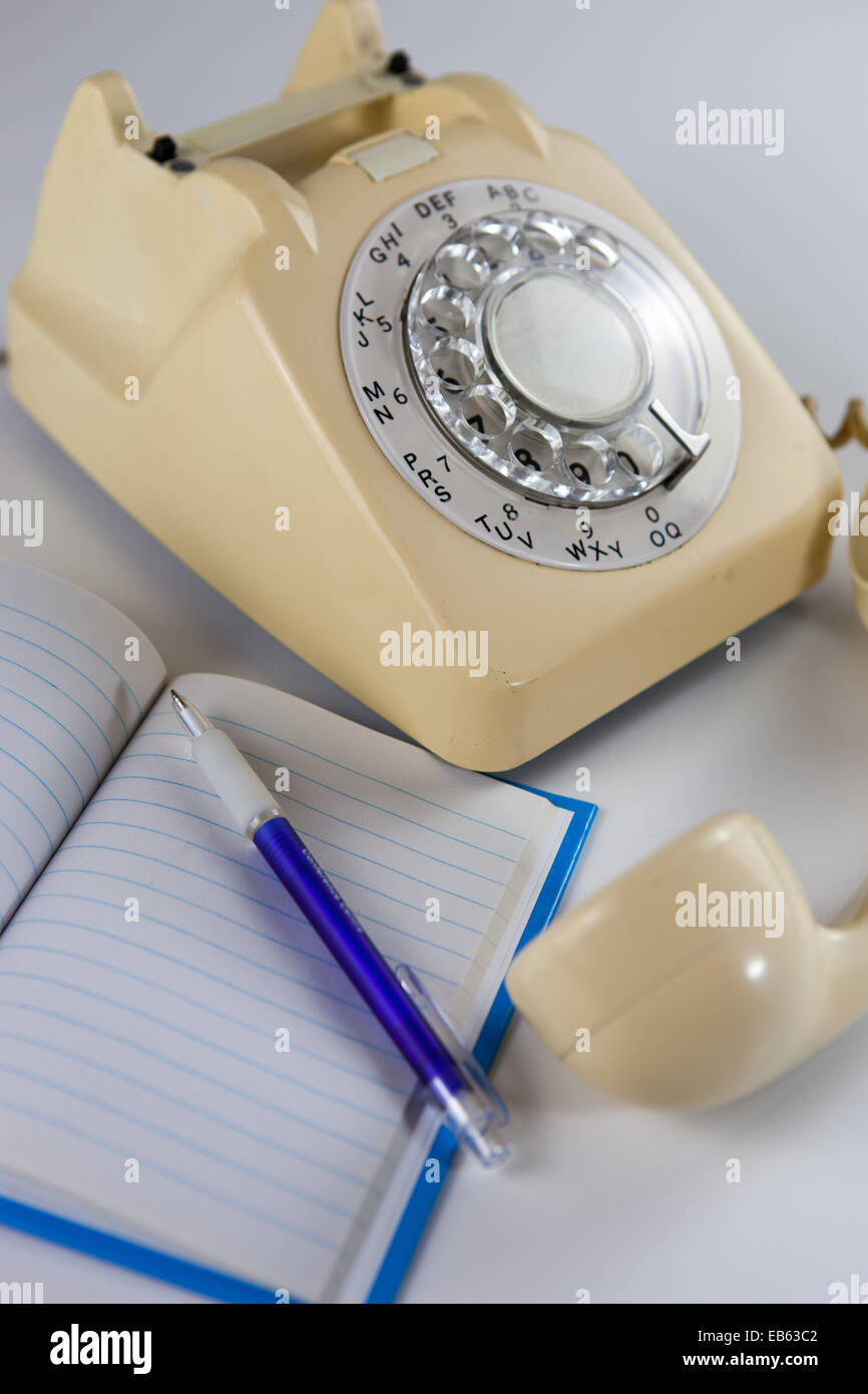 Old fashioned rotary dial telephone with notepad and pen Stock Photo ...