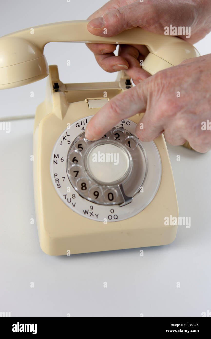 Dialing a number on an old fashioned rotary dial telephone Stock Photo ...
