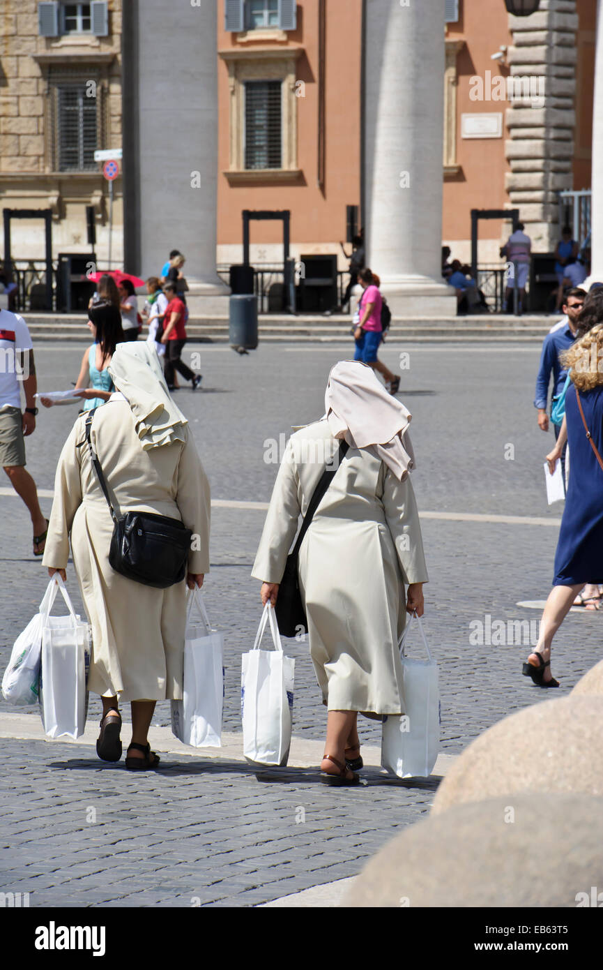 Nuns walking in Vatican Square with loaded shopping bags in City of ...