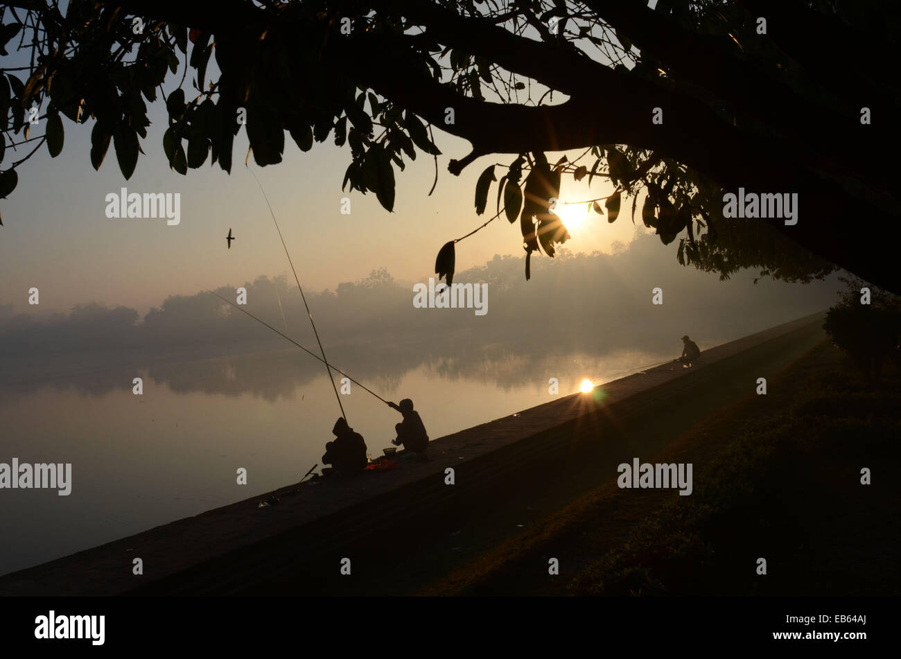 Residents fishing at Segaran pool in the village of Trowulan. An area ...