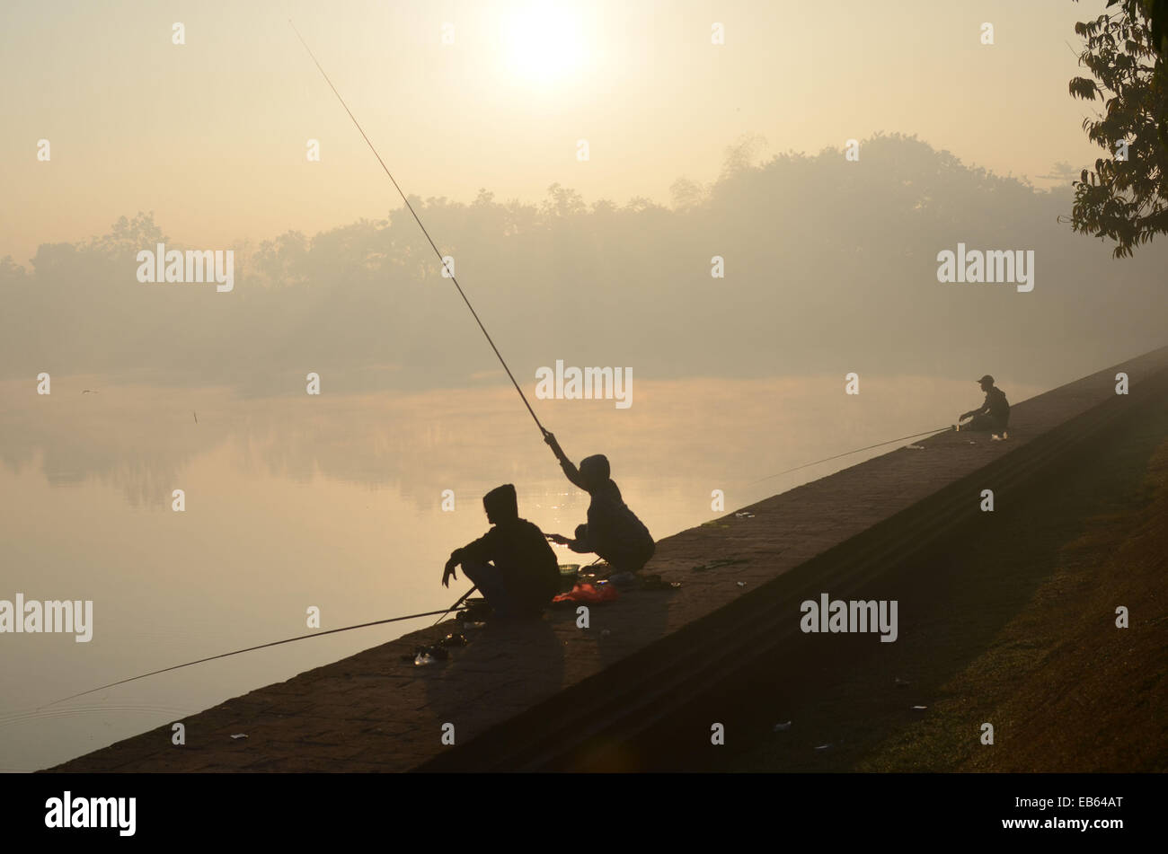Residents fishing at Segaran pool in the village of Trowulan. An area ...