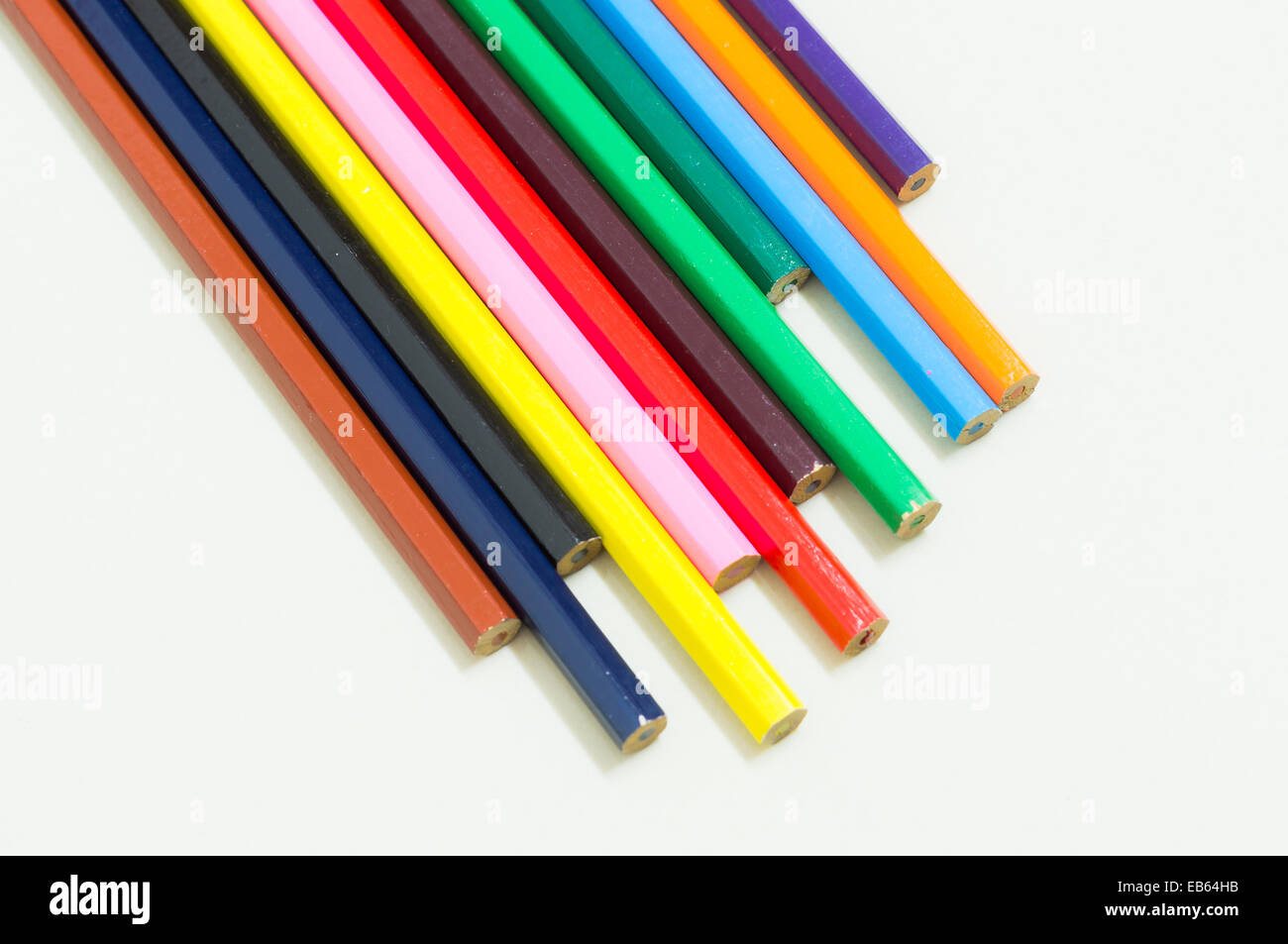 Colored pencils lined up in a row in the order of shade Stock Photo - Alamy