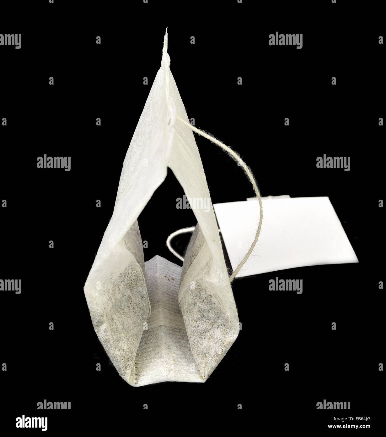 Single tea bag on a black background Stock Photo - Alamy