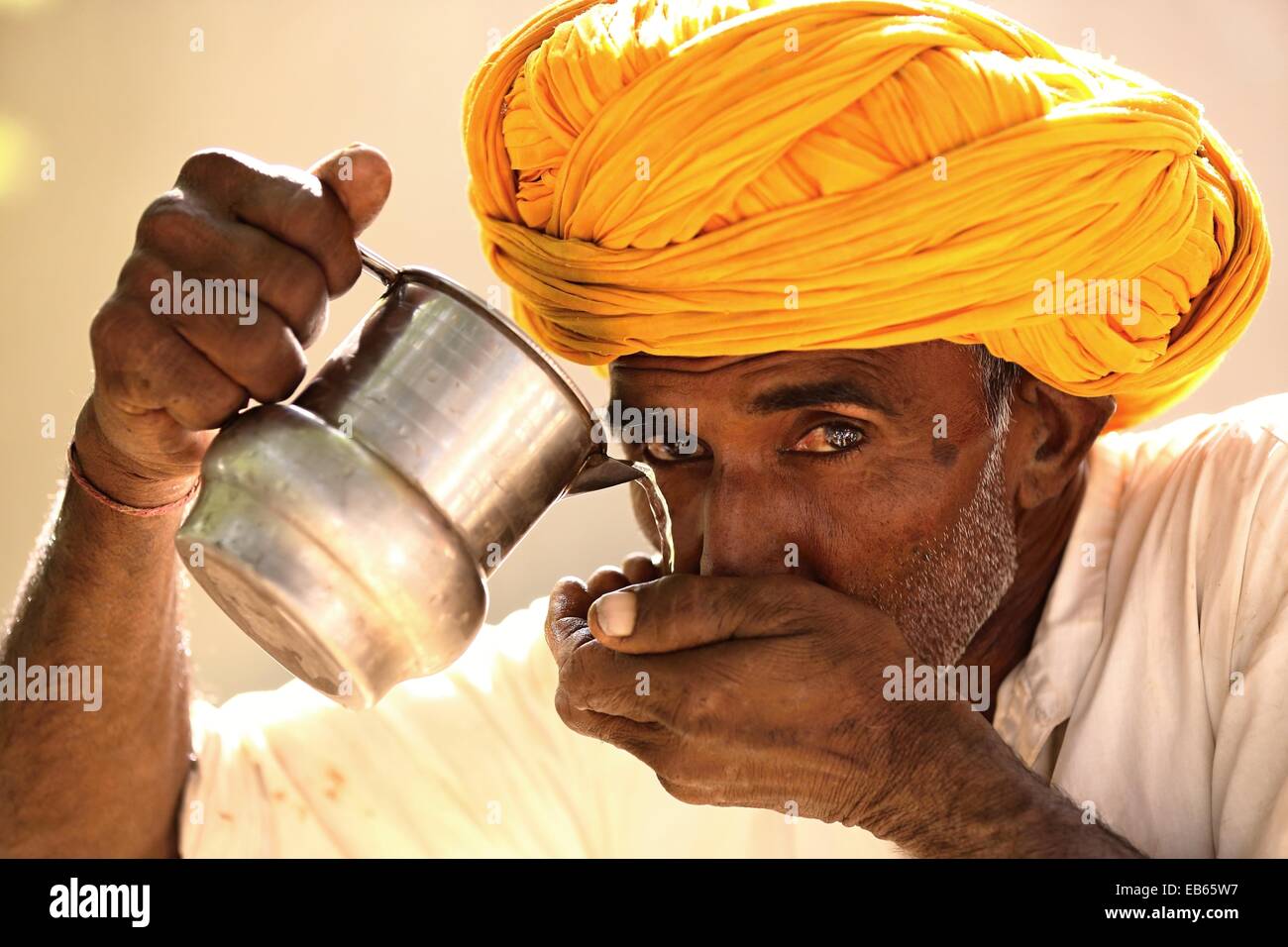 Indian man of Rajasthan drinking water portrait India Stock Photo - Alamy
