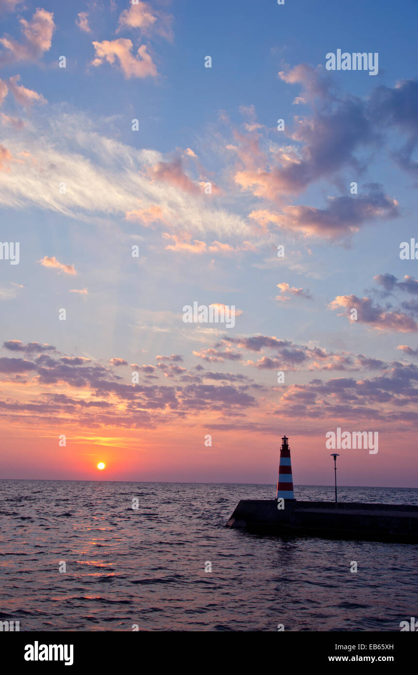 beautiful sea morning sunrise and lighthouse on pier Stock Photo - Alamy