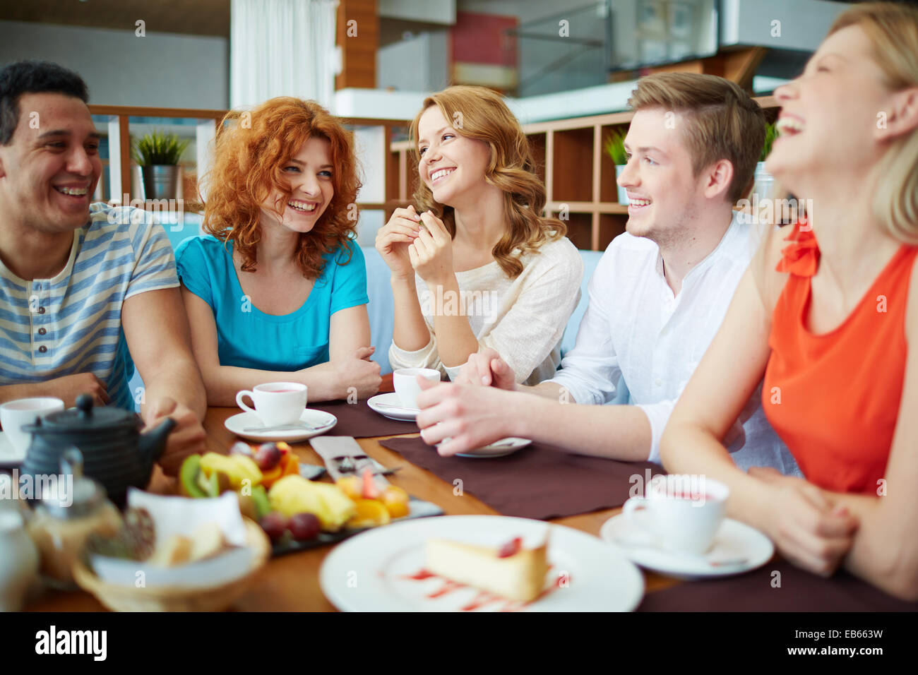 Group of friends having lunch at cafe Stock Photo - Alamy