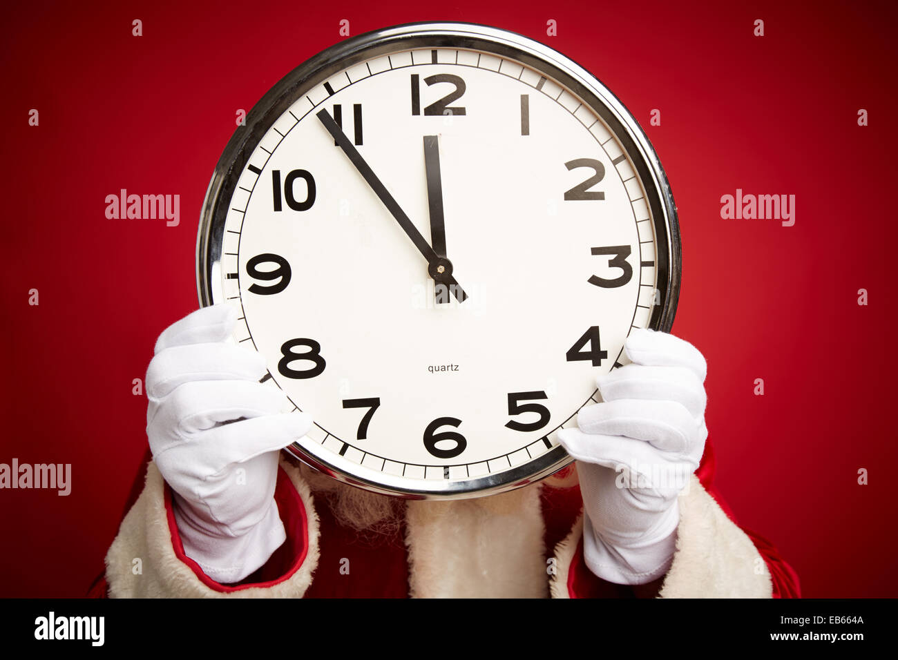 Hands of Santa holding clock with five minutes to twelve Stock Photo ...