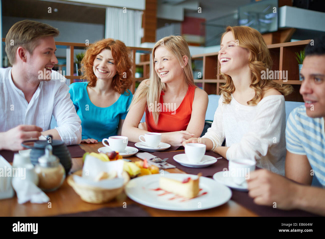 Group of friends drinking tea at café Stock Photo - Alamy
