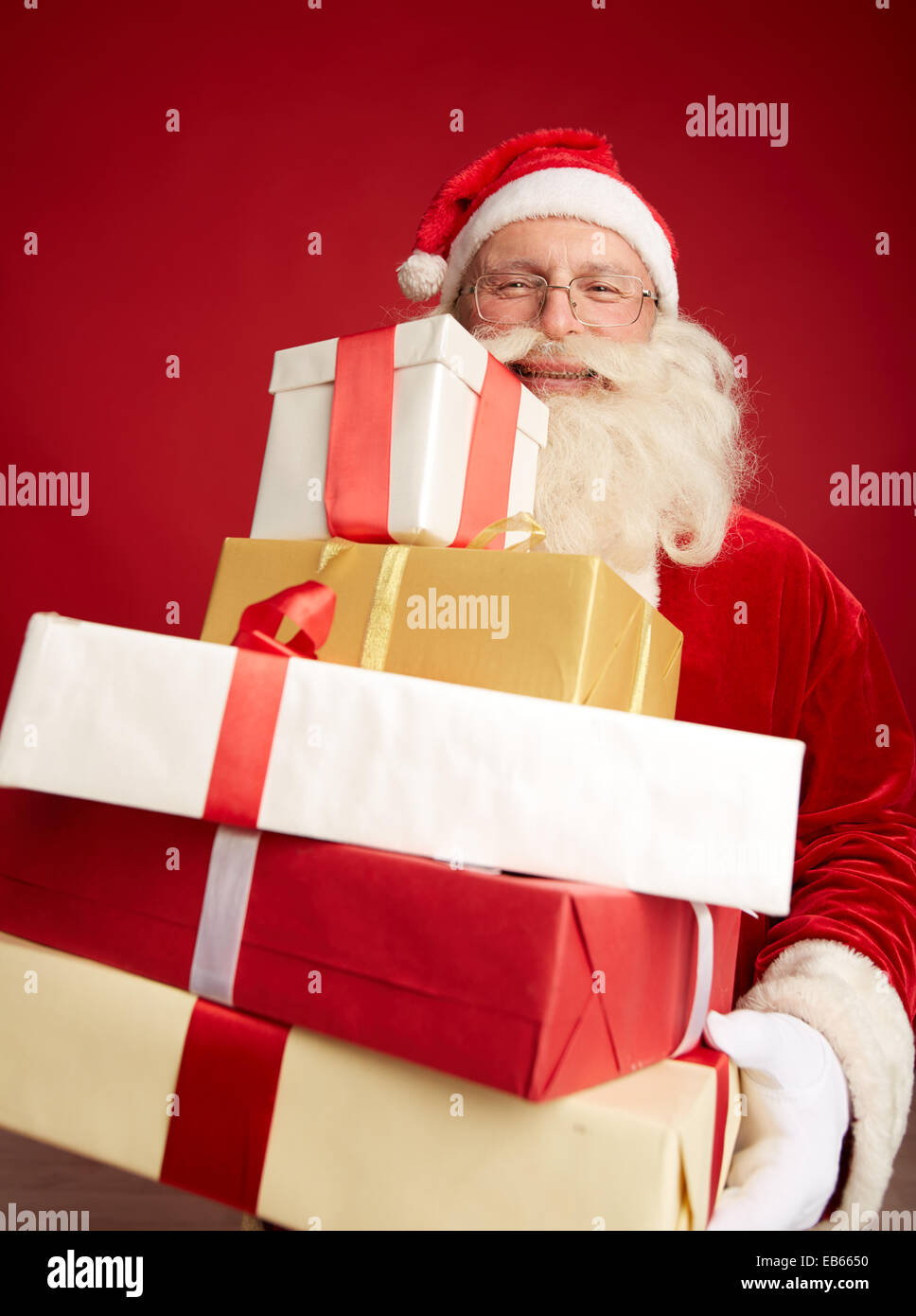 Generous Santa with pile of Christmas presents Stock Photo - Alamy