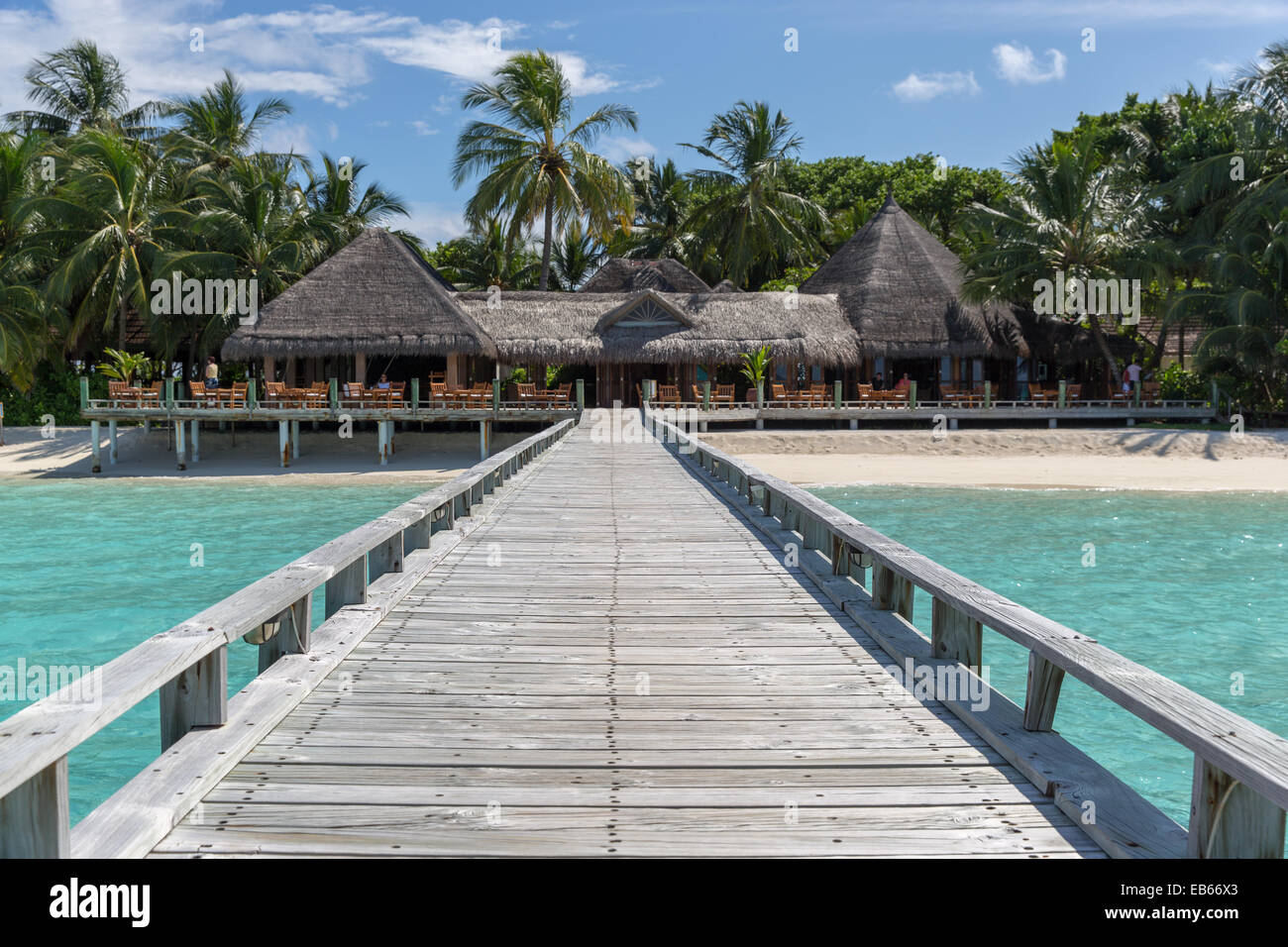 A wooden jetty outside the bar on a Maldivian Island Resort in the ...