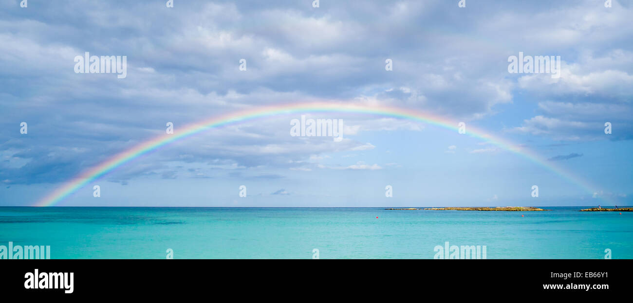 Rainbow over ocean Stock Photo - Alamy