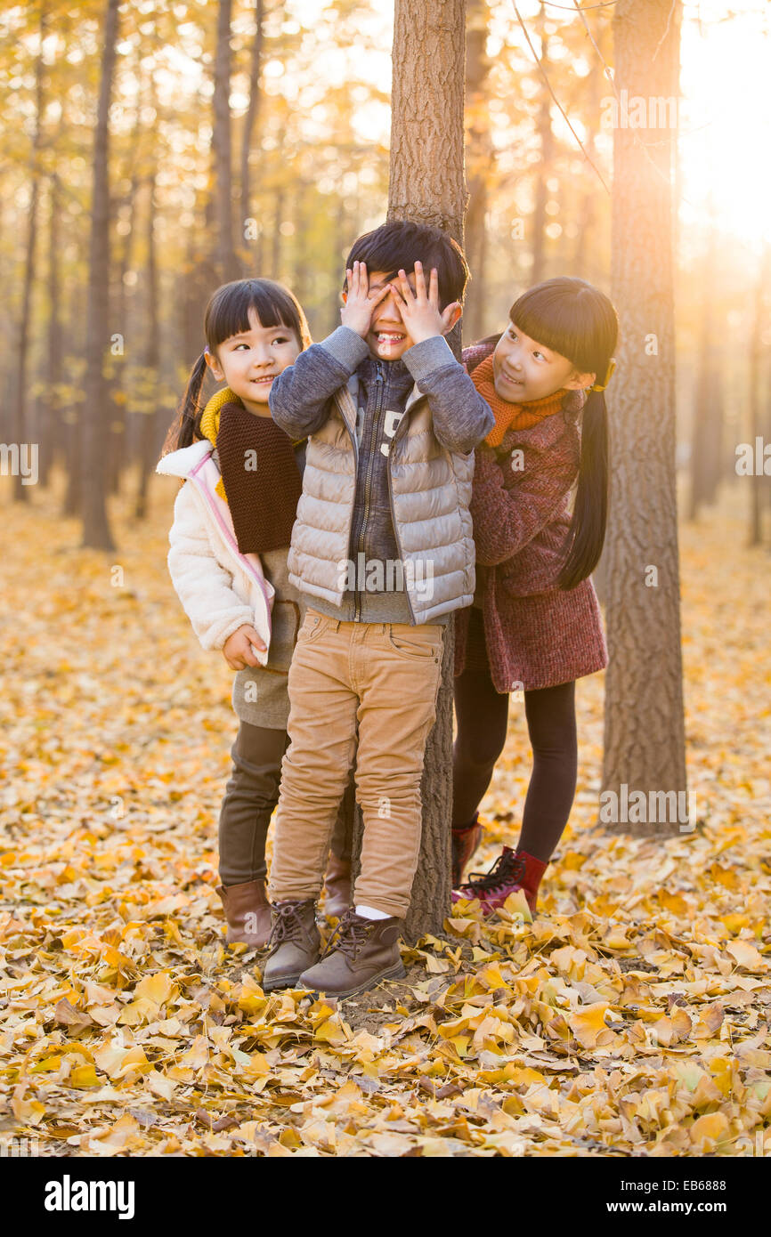 Three girls playing hide seek hi-res stock photography and images - Alamy