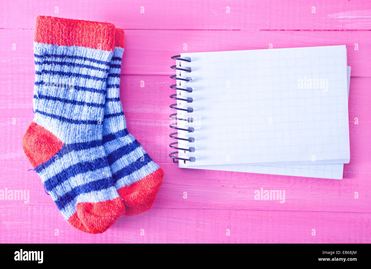 baby socks on the pink wooden table Stock Photo - Alamy