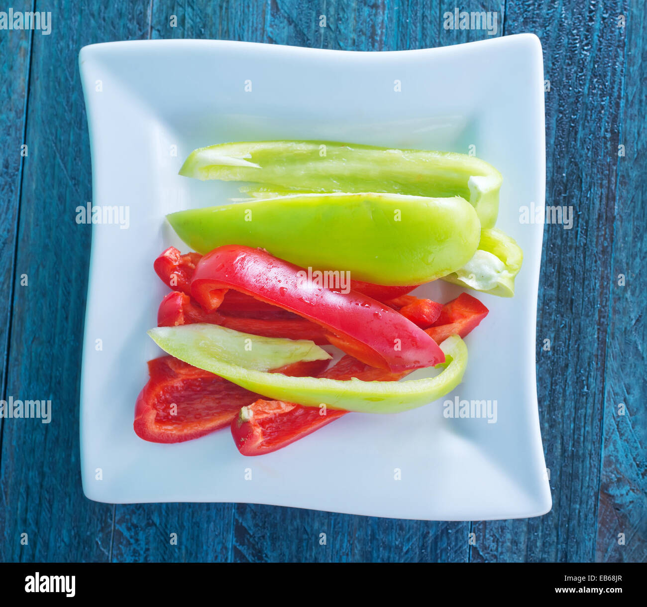 color pepper on the plate and on a table Stock Photo - Alamy