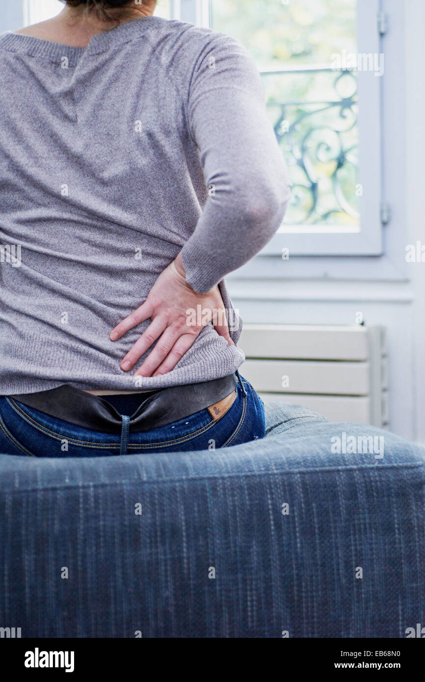 WOMAN WITH LOWER BACK PAIN Stock Photo - Alamy