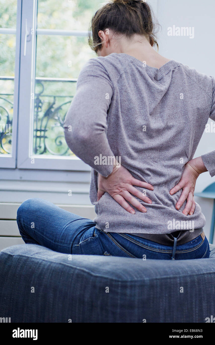 WOMAN WITH LOWER BACK PAIN Stock Photo - Alamy