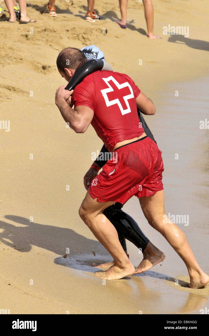 Red Cross lifeguard aiding a swimmer. Barcelona, Catalonia, Spain Stock ...