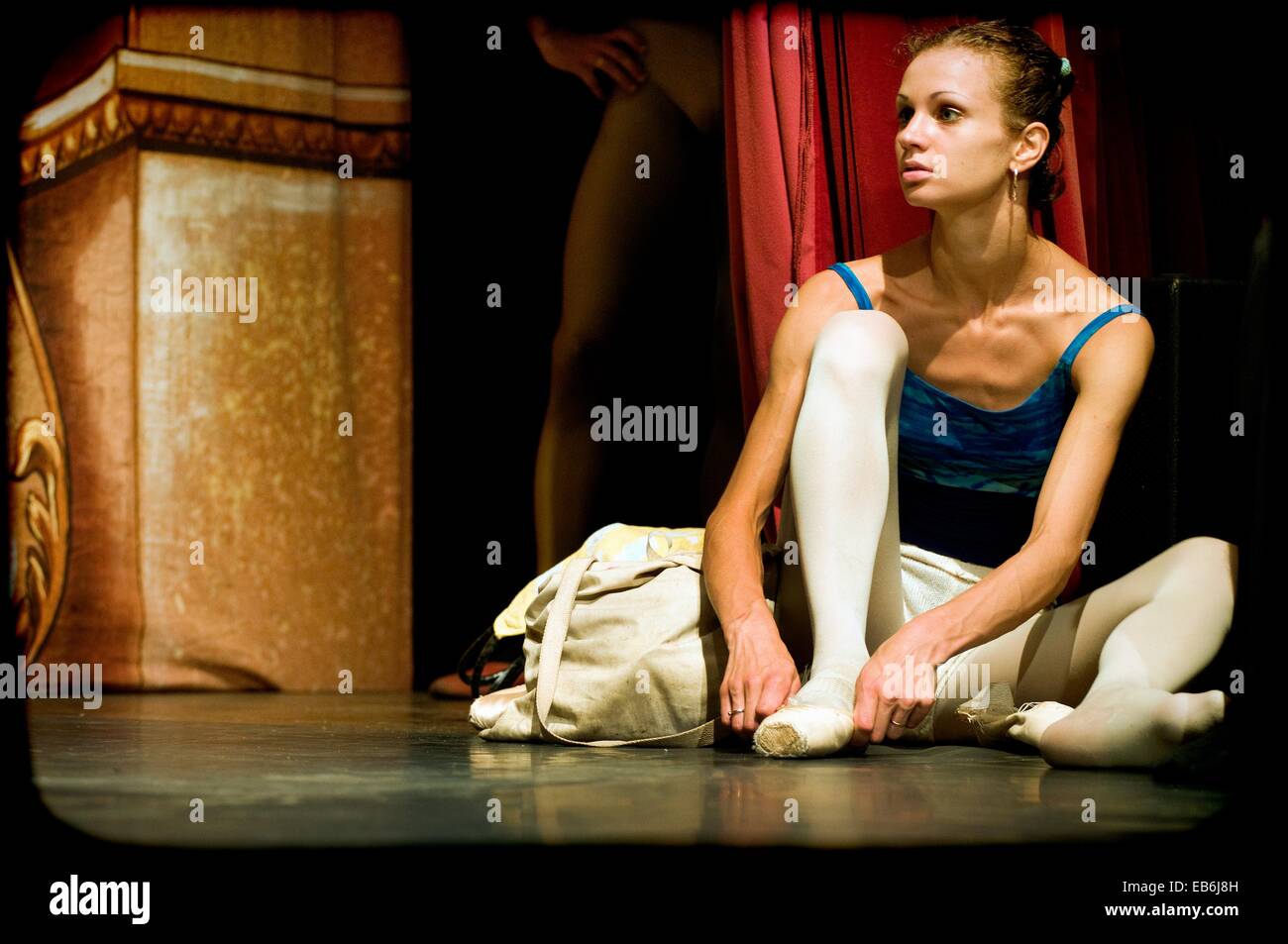 Classical ballet dancer sitting resting at trial Stock Photo - Alamy