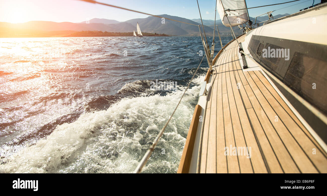 Yacht sailing towards the sunset. Sailing. Luxury yachts Stock Photo ...