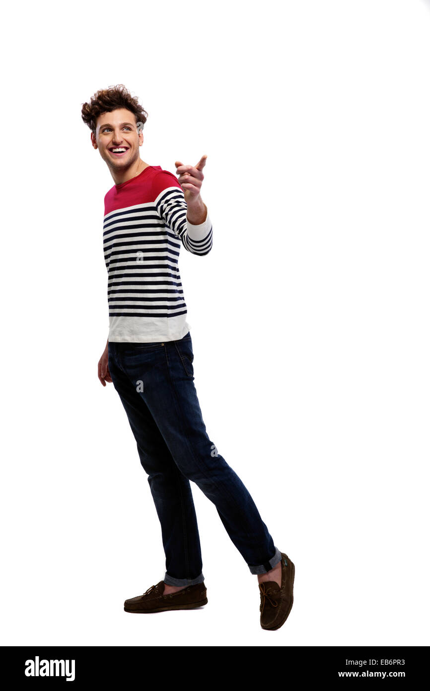 Smiling man pointing away over white background Stock Photo - Alamy