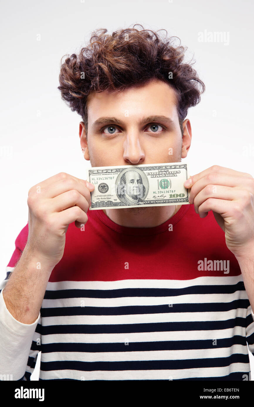 Portrait of a man holding money over gray background Stock Photo - Alamy