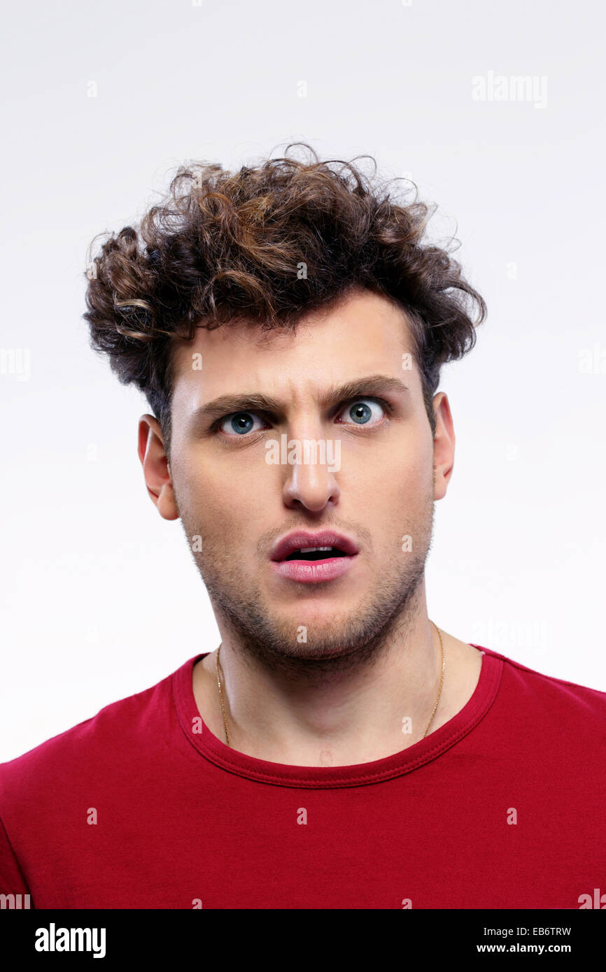 Surprised man isolated over gray background Stock Photo - Alamy